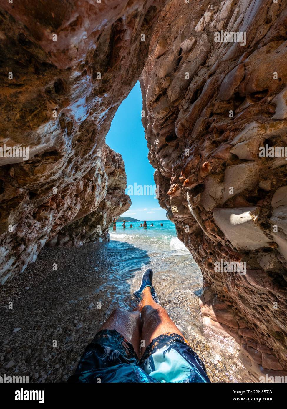 Sitting on the paradise beach of Kroreza or Krorez in a cave on the ...