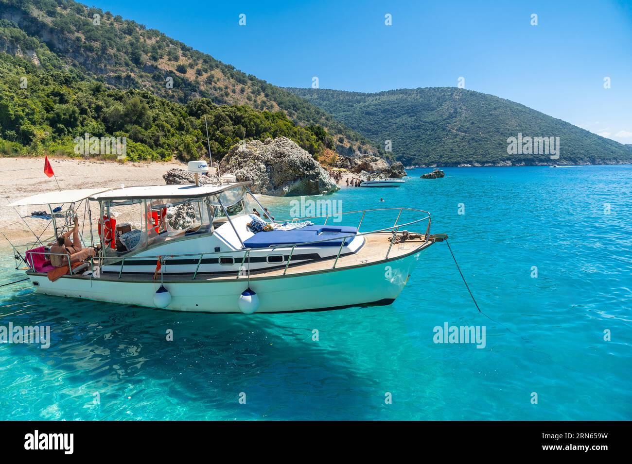 Boat in the transparent waters of the paradise beach of Kroreza or ...