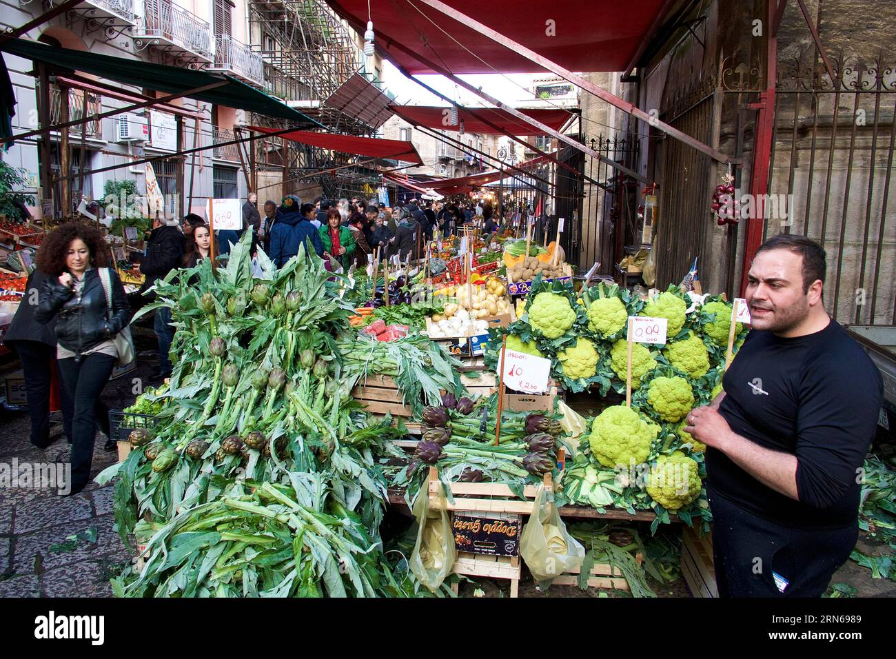 Vegetable stall, vegetables in pile, narrow market alley, vendors ...