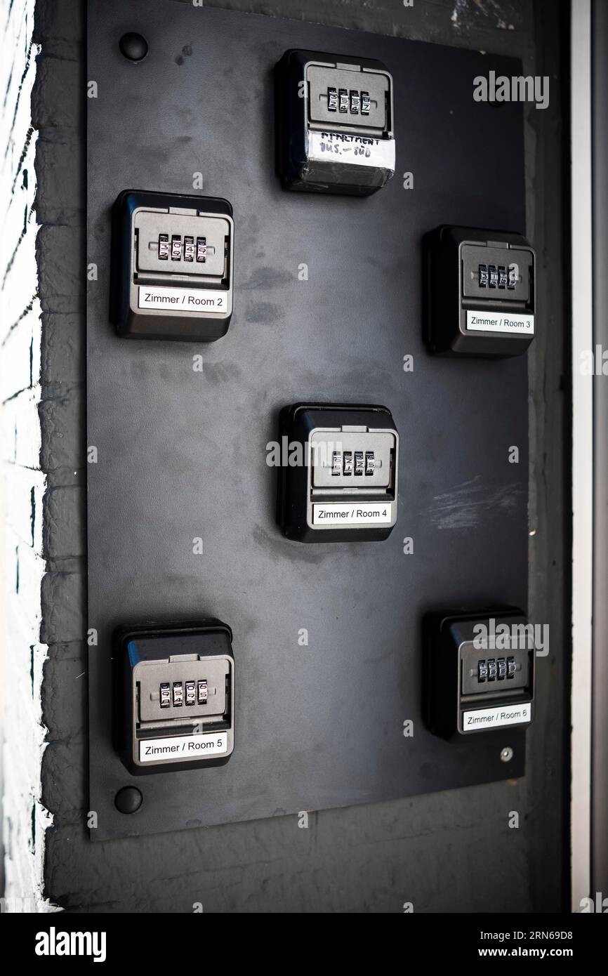 Combination locks for deposited keys for access to rooms in a hotel ...