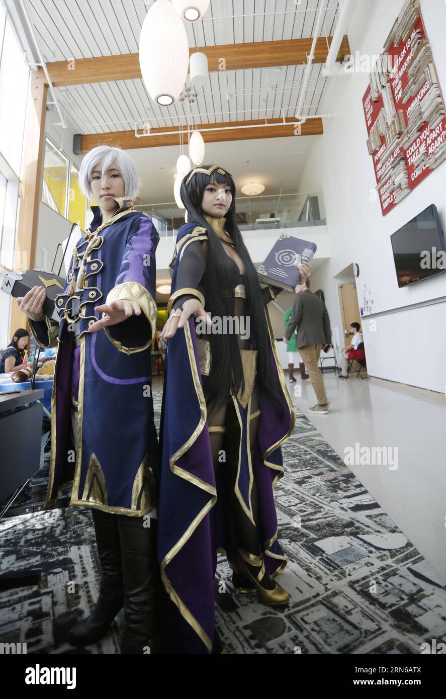 Attendees in cosplay costumes poses during the Anime Evolution ...