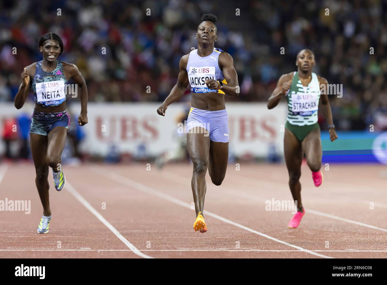 Shericka Jackson of Jamaica, center, crosses the finish line to win the Women's 200m Final race ...