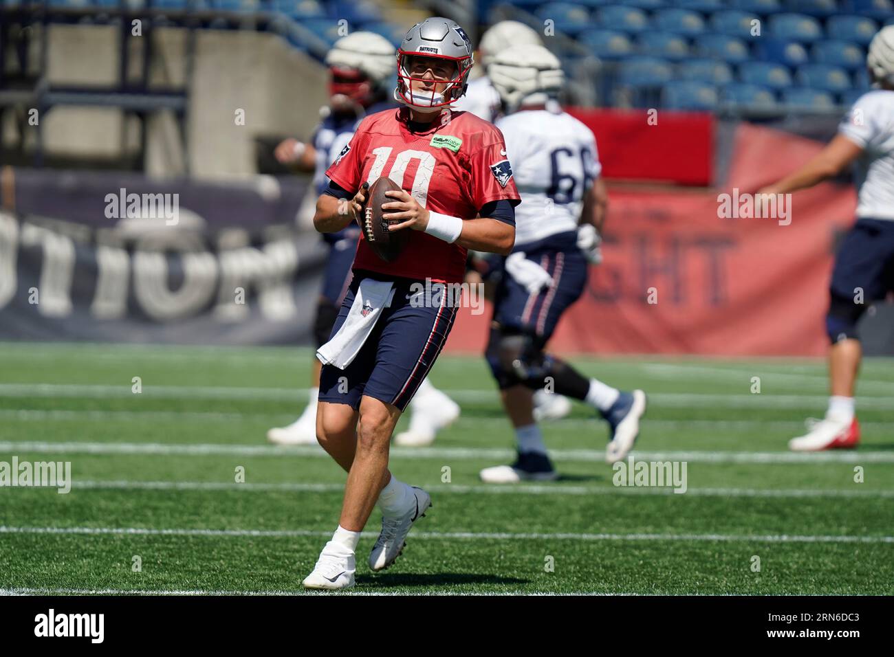New England Patriots quarterback Mac Jones (10) performs field drills ...