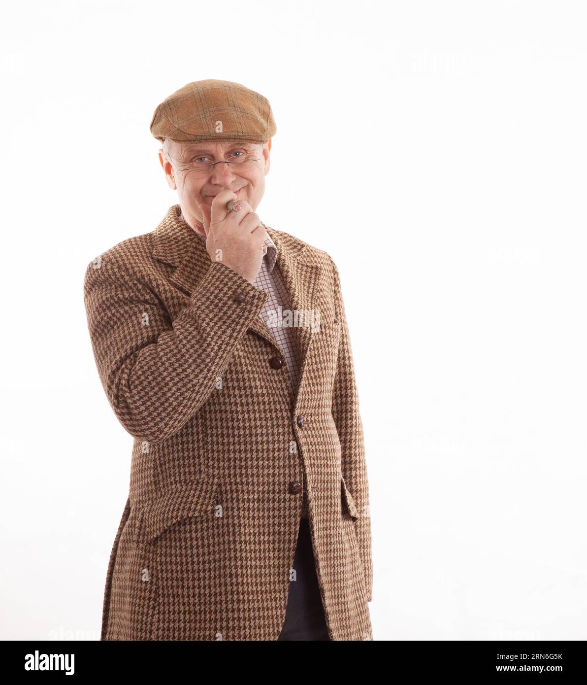 A mature Englishman in classic tweeds smoking a large cigar Stock Photo ...