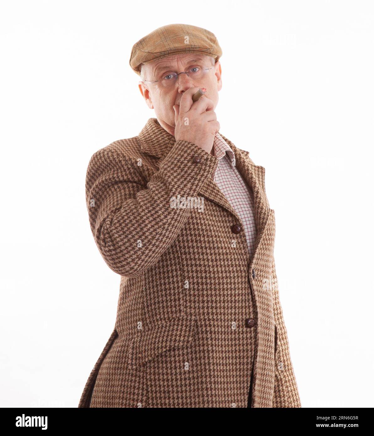 A mature Englishman in classic tweeds smoking a large cigar Stock Photo ...