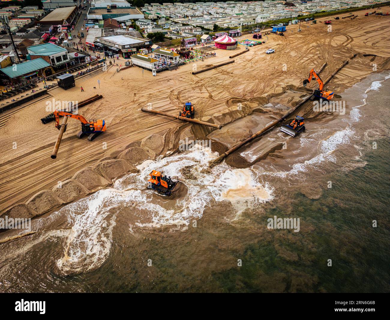 Construction vehicles performing beach works. They're building up flood ...