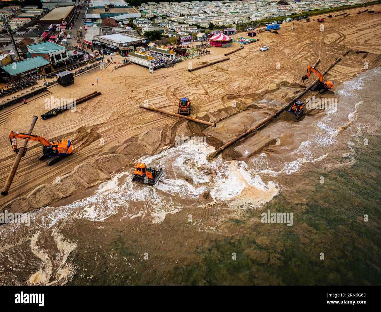 Construction vehicles performing beach works. They're building up flood ...