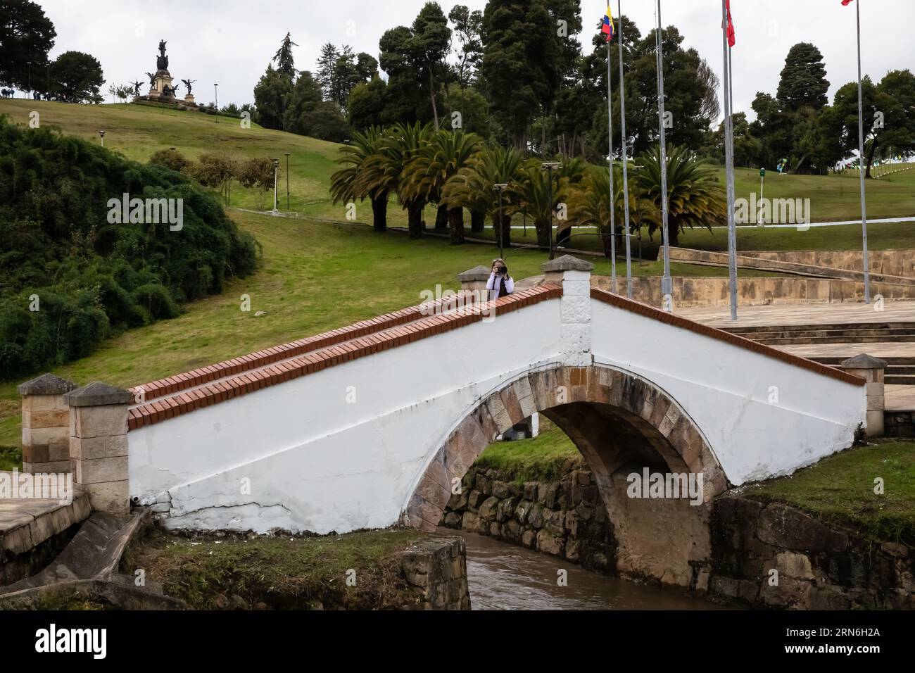 Female tourist taking pictures at the famous historic Bridge of Boyaca ...