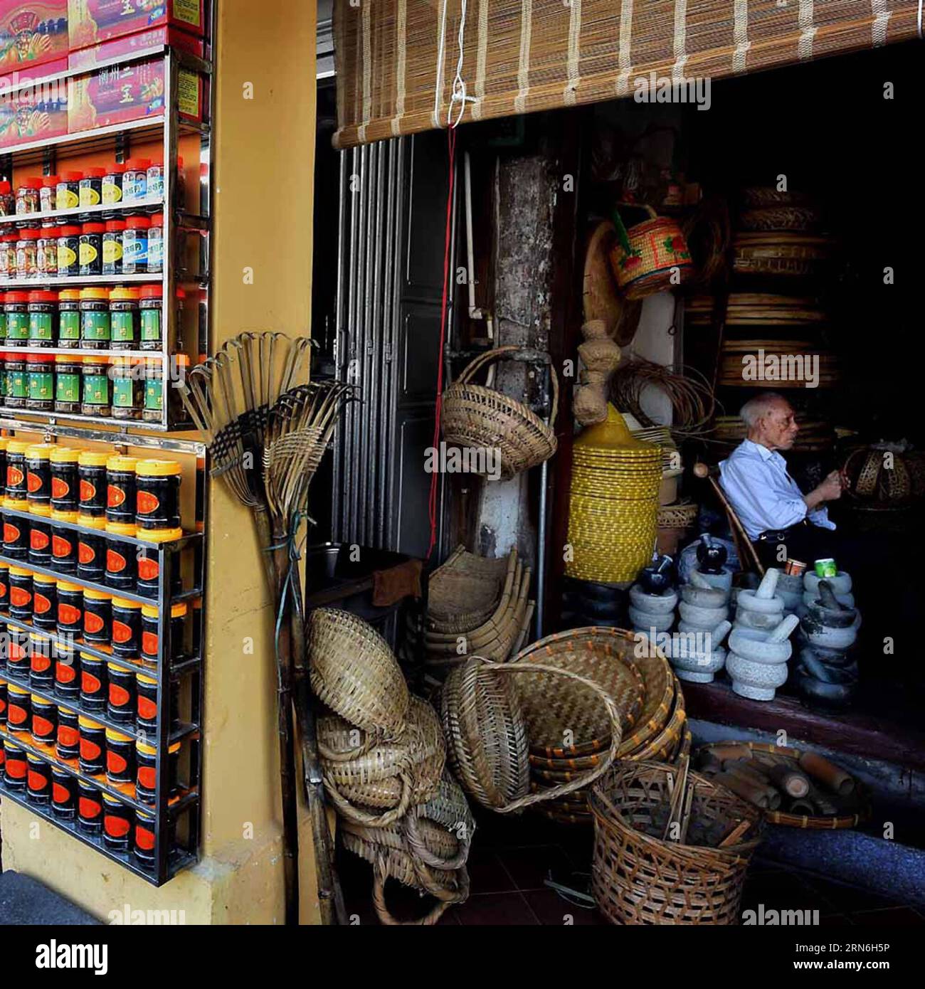 Photo taken on Oct. 27, 2014 shows a shop owner waiting for customers ...