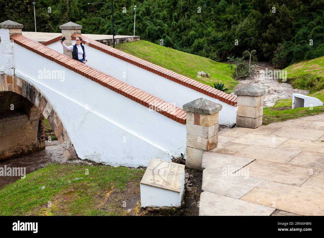 Female tourist taking selfies at the famous historic Bridge of Boyaca ...