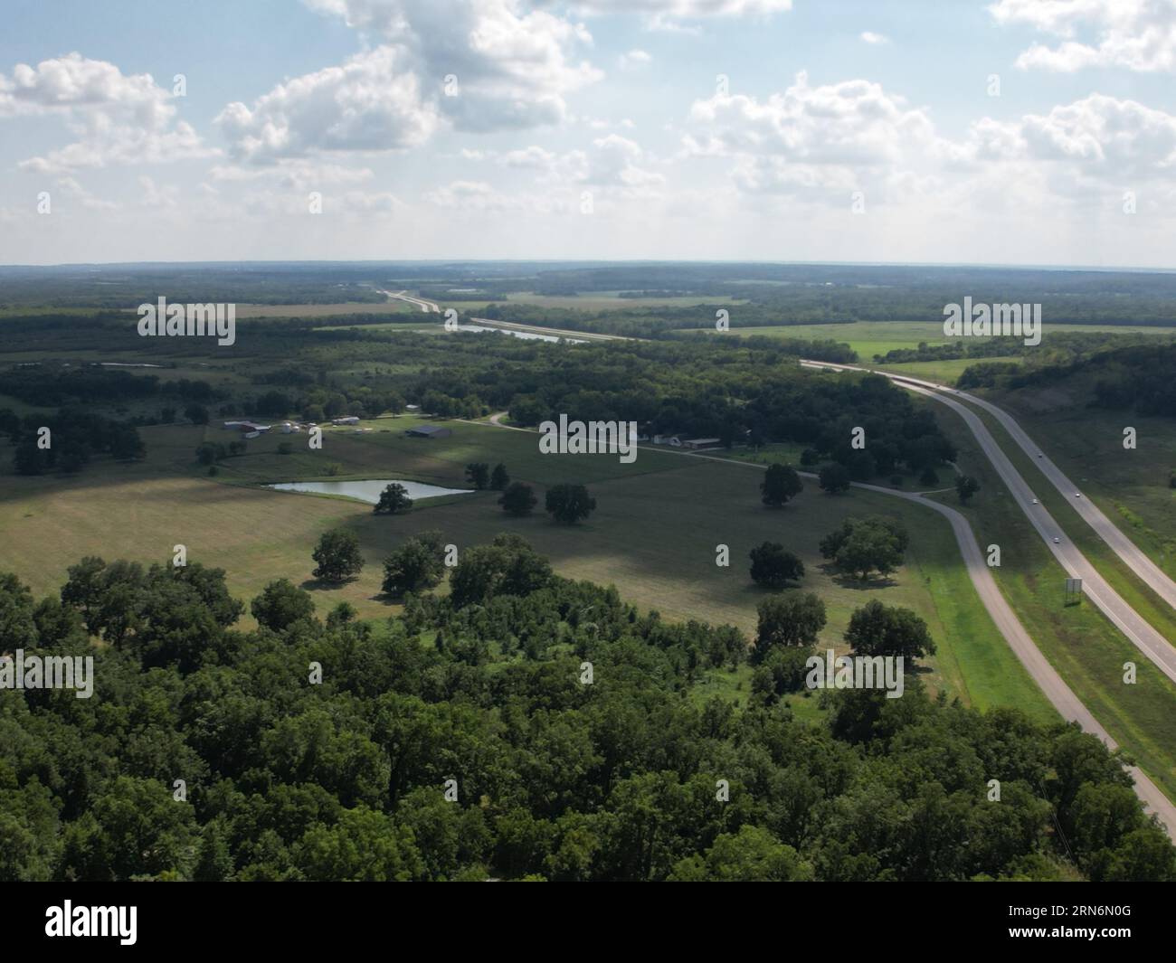 A winding highway stretches across a sprawling countryside landscape ...