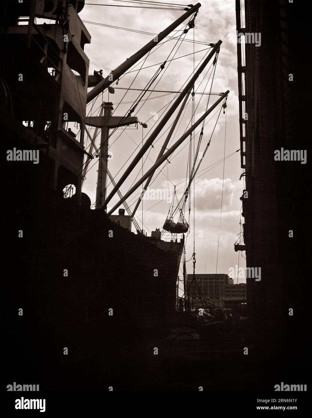 1950s SILHOUETTE OF CARGO SHIP UNLOADING AT COMMONWEALTH PIER BOSTON ...