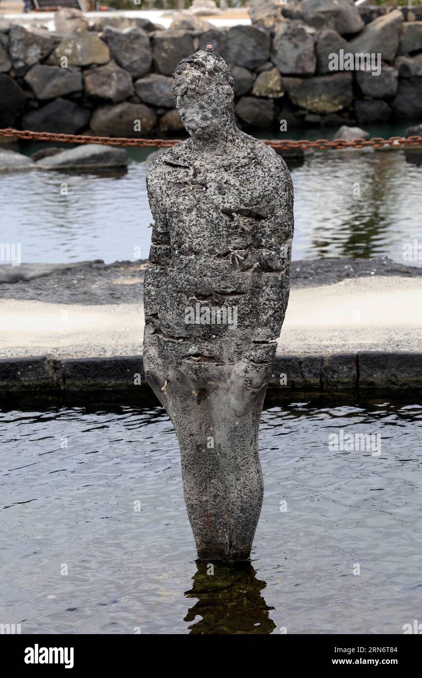 Statue of human figure as a water fountain in a small lake, Marina ...