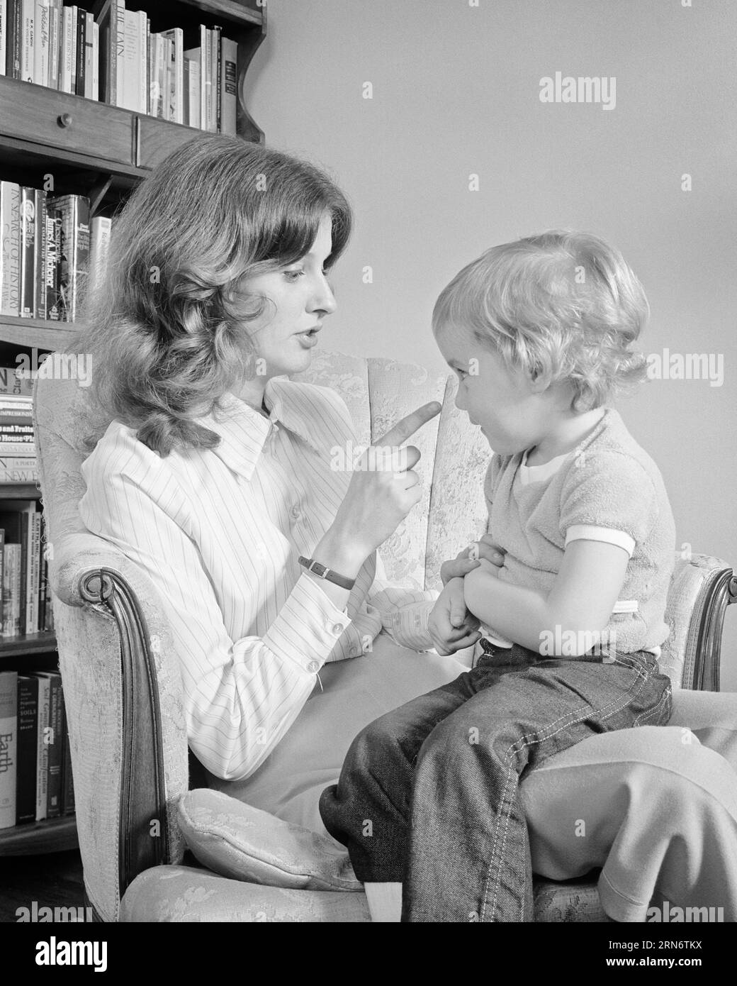 1970s 1980s BOY TODDLER SITTING ON MOTHER'S LAP BEING SCOLDED MOTHER ...