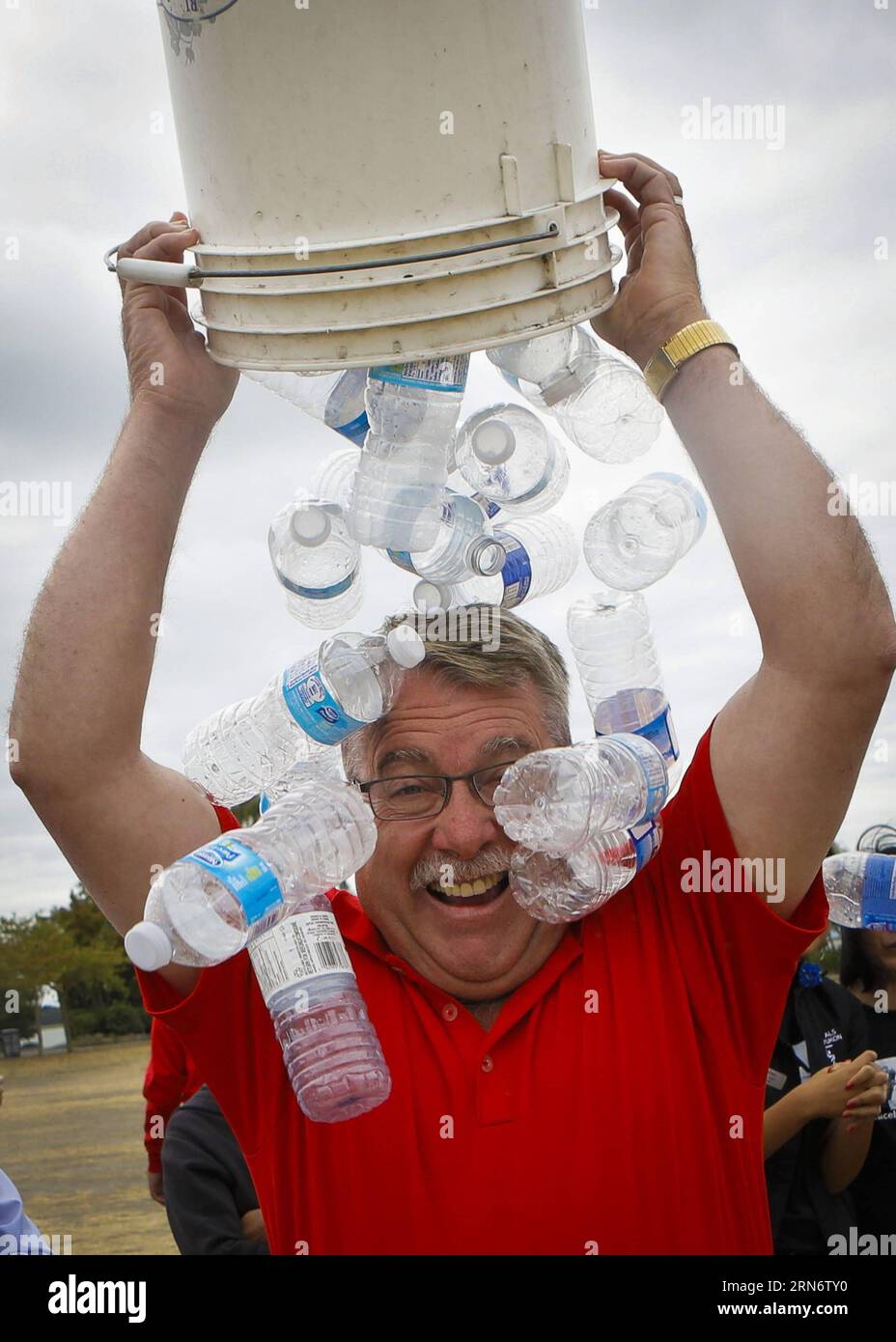 (150807) -- VANCOUVER, - A man pours over himself a bucket of plastic ...