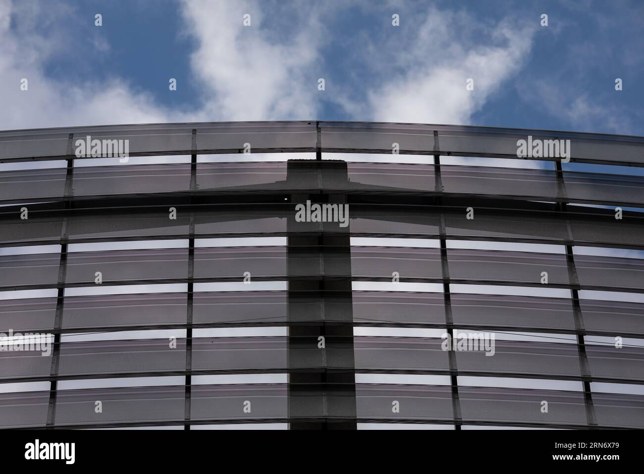 A modern sports hall with a panel facade that mimics louvers Stock ...