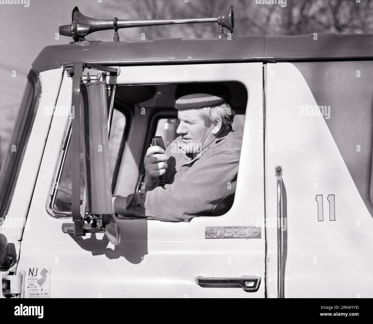 1970s TRUCK DRIVER TALKING ON CB RADIO IN WINDOW OF TRUCK CAB - r24362 ...