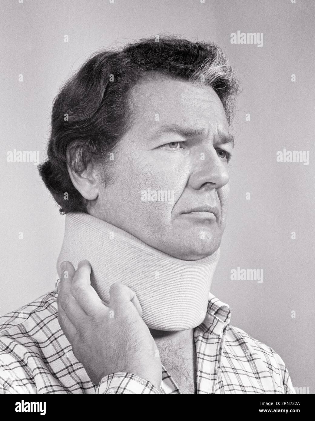 1970s MAN PAINED FACIAL EXPRESSION WEARING A CERVICAL COLLAR - a8506 ...
