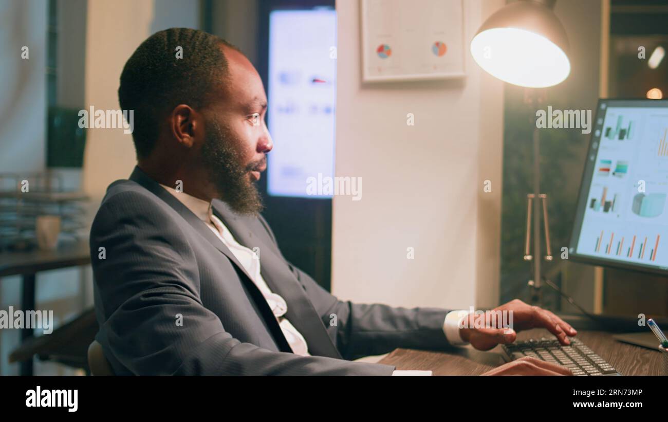 Dolly out shot of meticulous coworkers crosschecking accounting datasets in office during ...