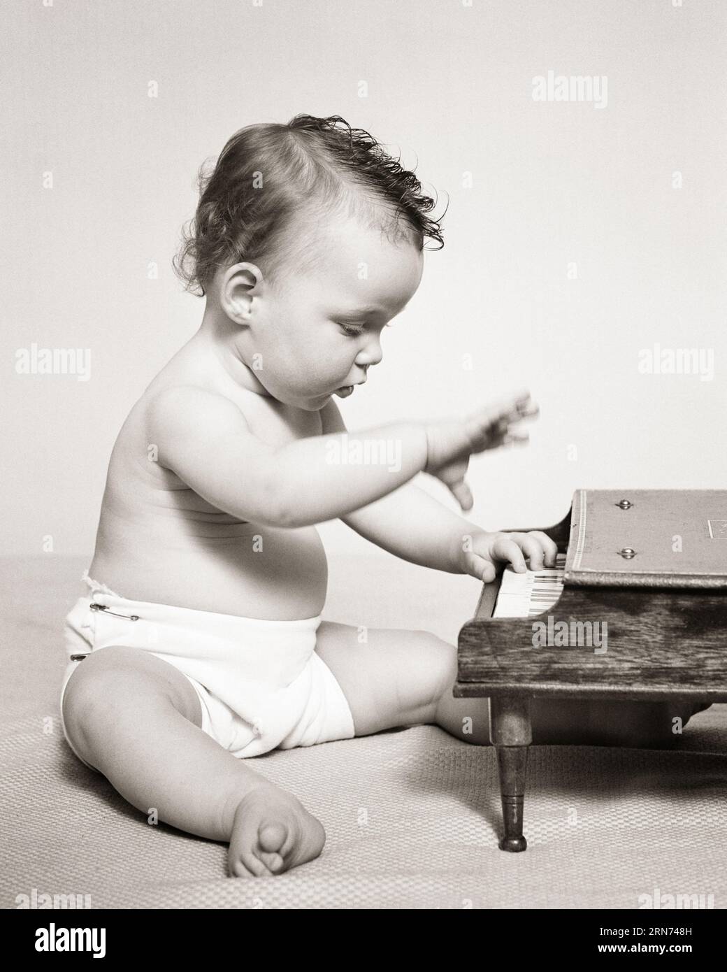 1940s BABY WEARING A CLOTH DIAPER WITH SAFETY PINS SITTING PLAYING A ...