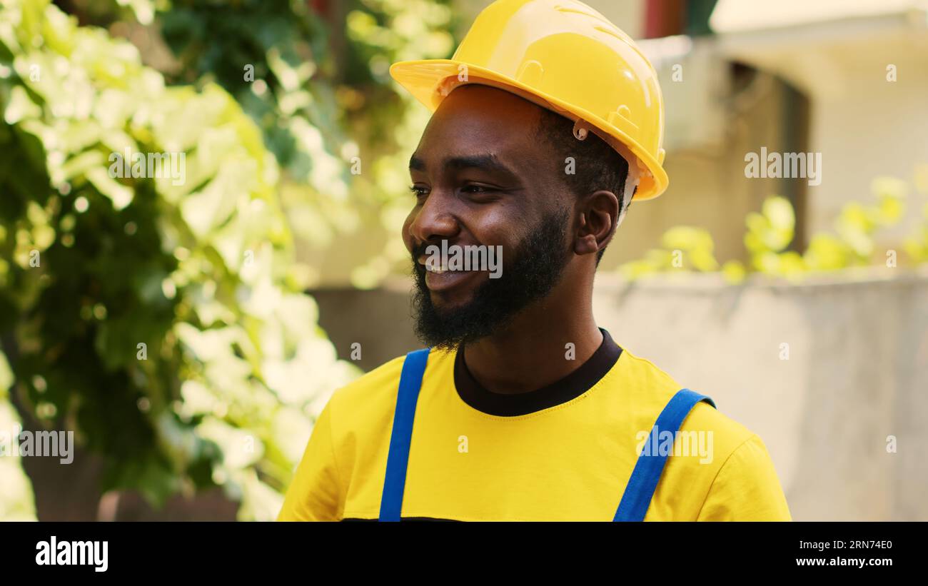 Revealing shot of smiling repairman happy with freon levels in outdoor ...