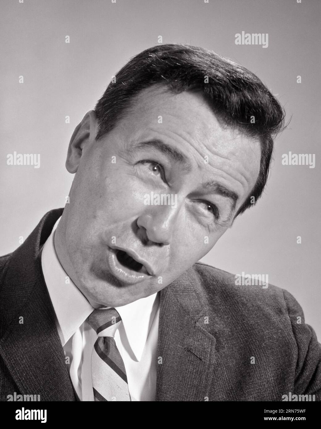 1960s PORTRAIT OF ANGRY CAUCASIAN MAN WITH HEAD TILTED INTERROGATING ...