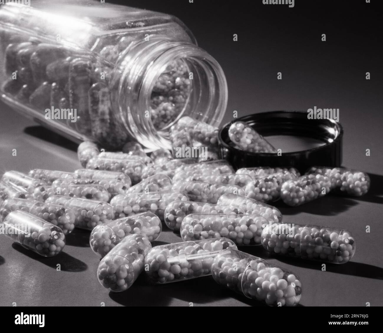 1970s OPEN MEDICINE BOTTLE WITH CAPSULES PILLS SPILLING OUT - s18626 ...