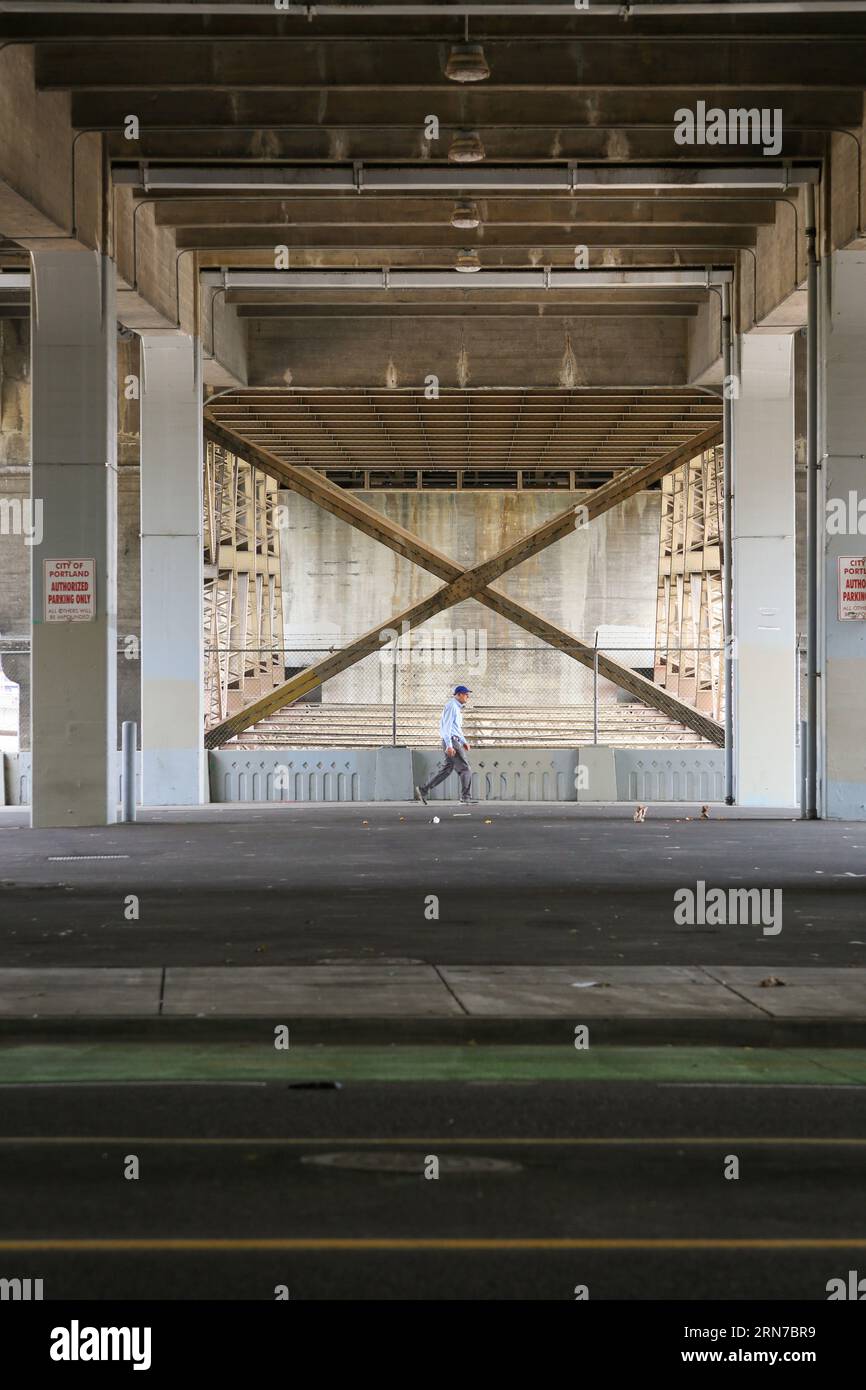 Person running on a path under a bridge in downtown Portland Oregon ...