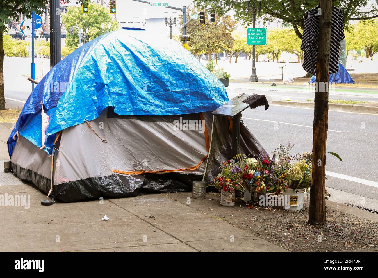 Homeless persons tent on the sidewalk next to a memorial in downtown ...