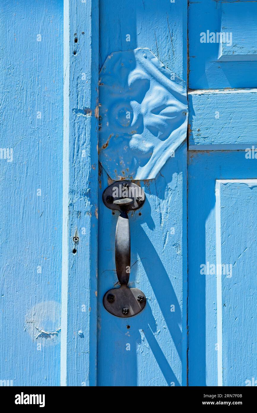 Close up iron gate latch on blue wood panel door Stock Photo - Alamy