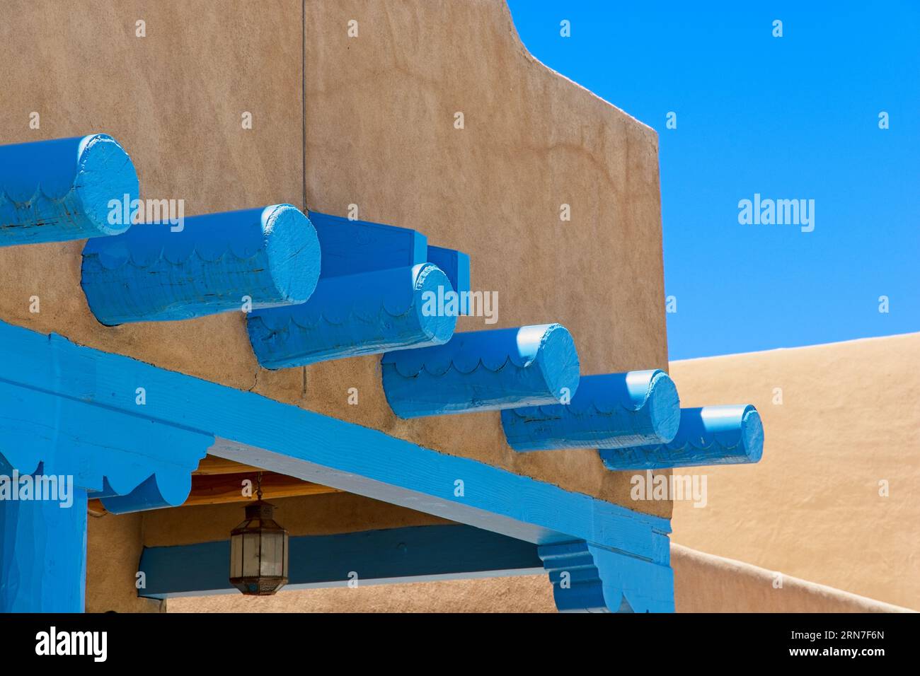 Blue wooden viga roof beams on adobe structure in shopping district of ...