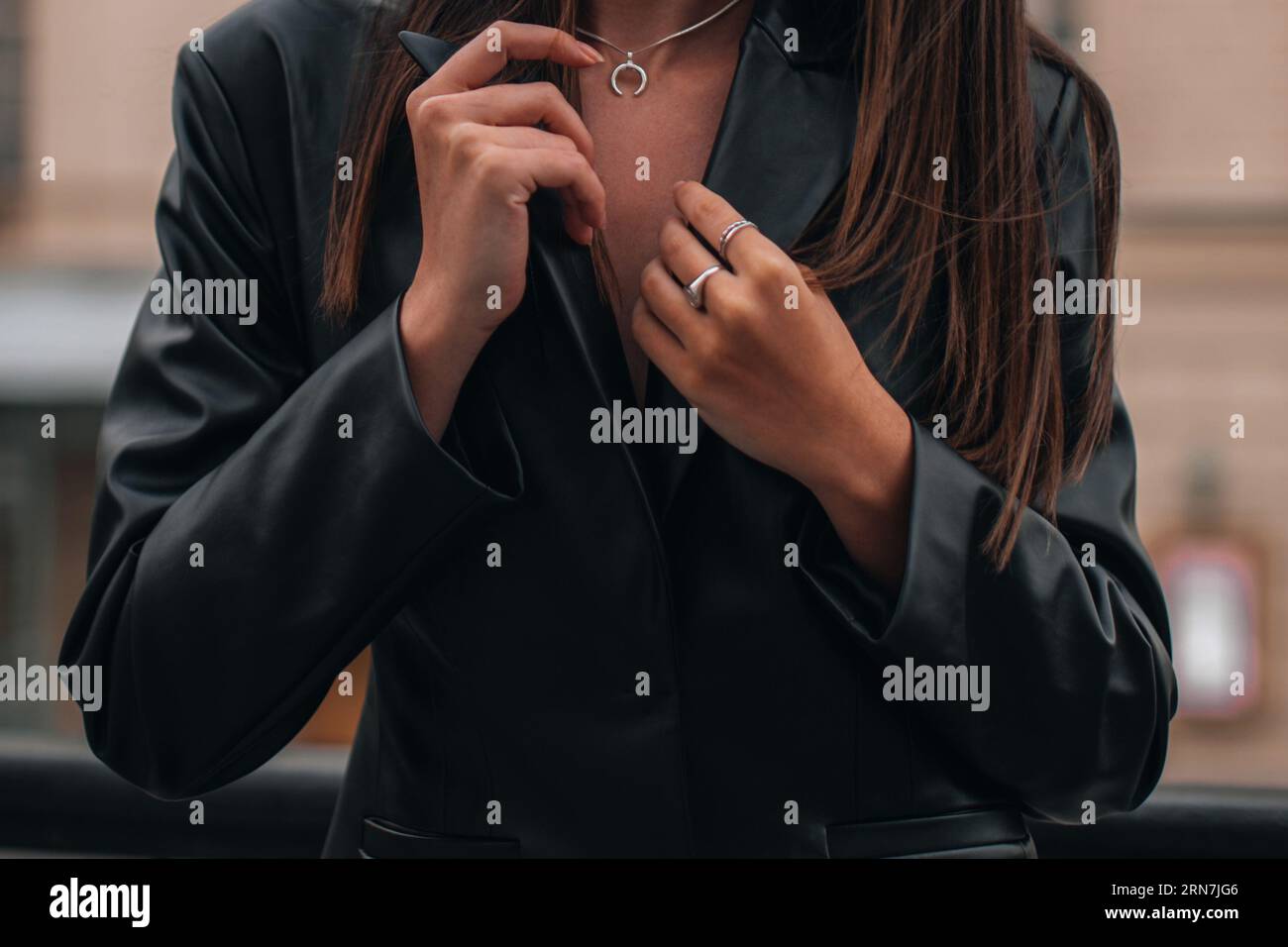 Fashion details of a black leather jacket and silver accessories. Fancy ...