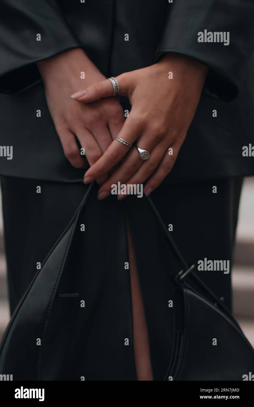 Fancy details of a black leather stylish cloth and silver accessories ...