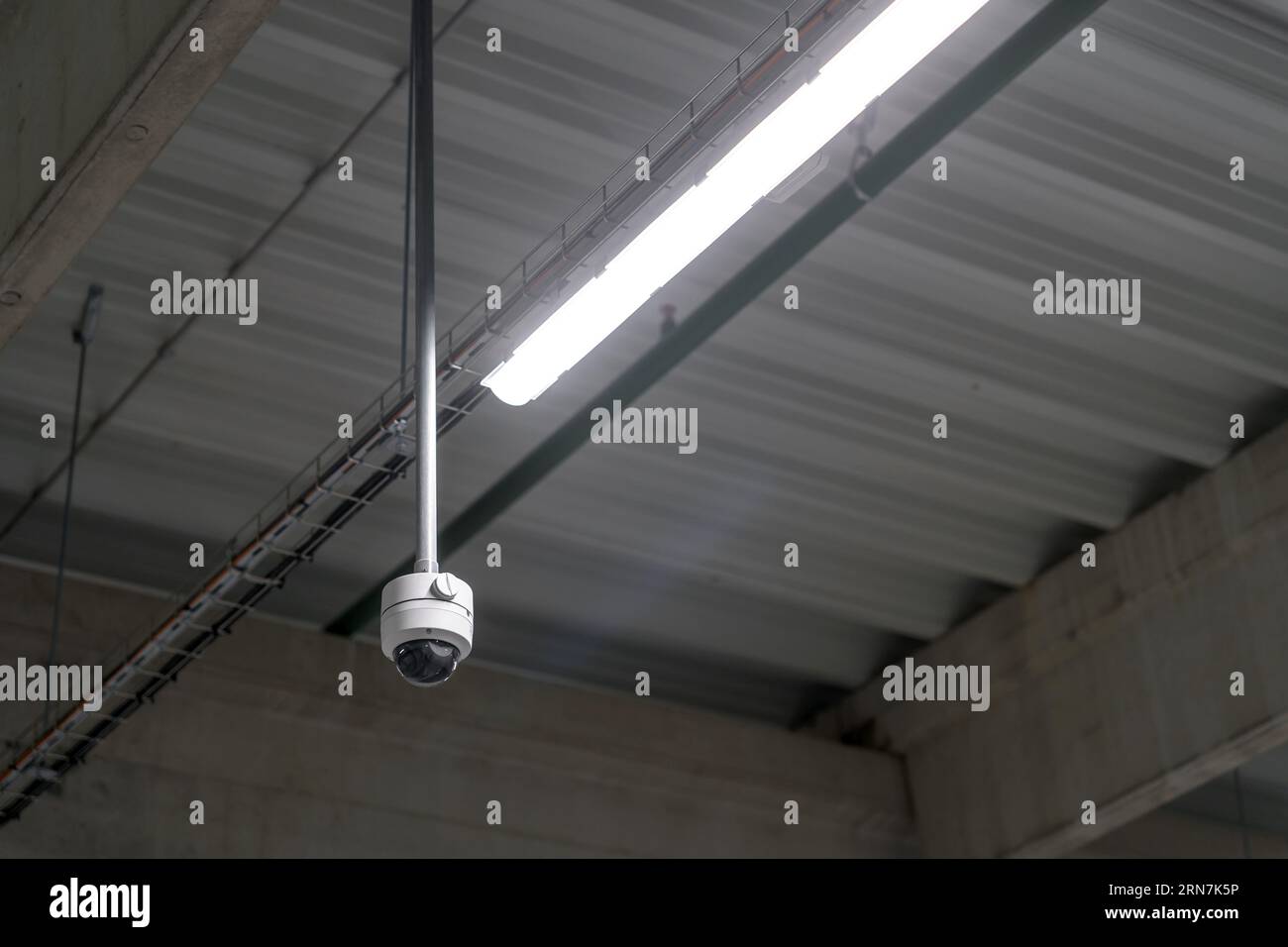 Digital surveillance camera on the ceiling in a warehouse room Stock ...