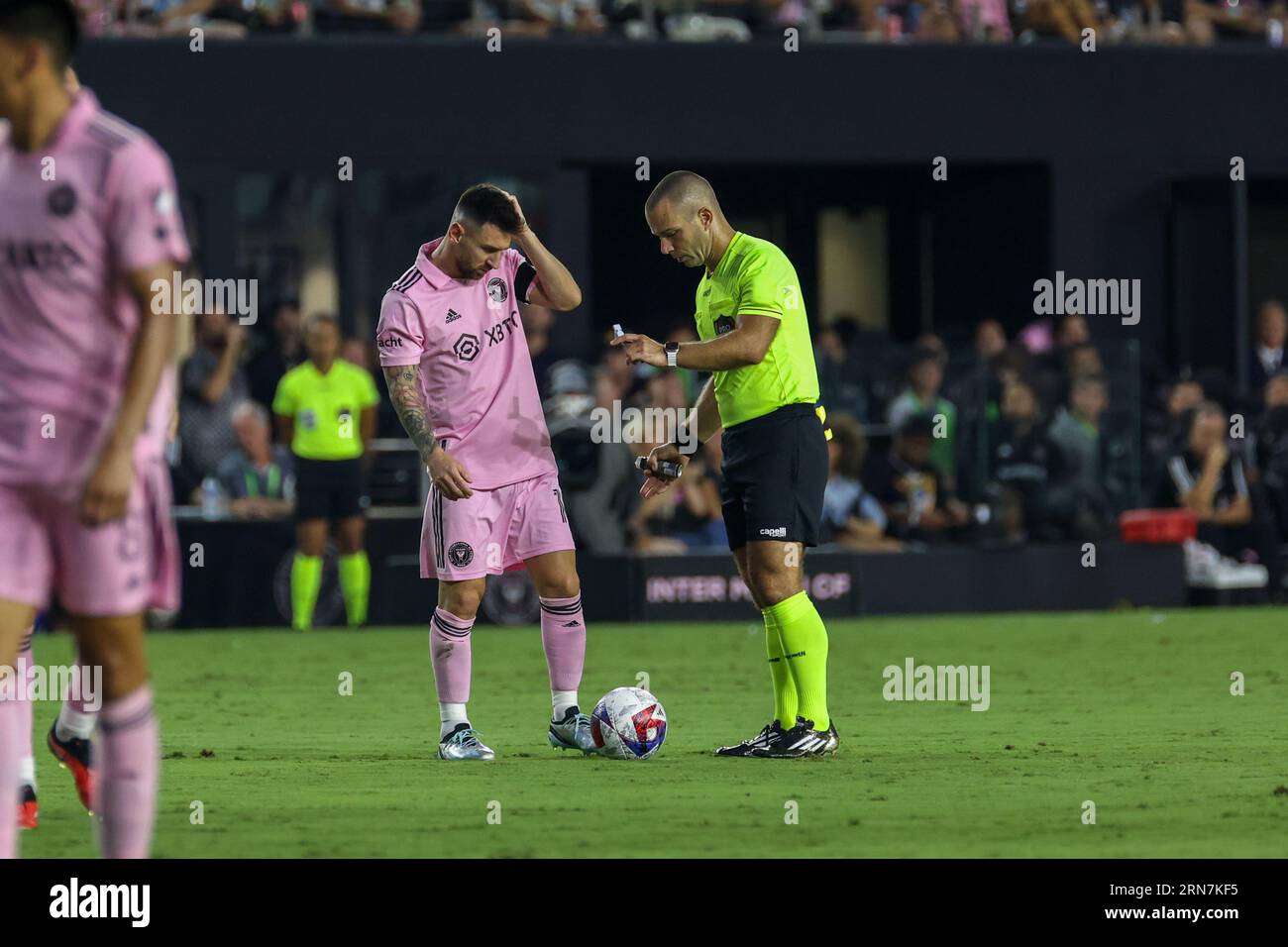 Lionel Messi awaiting the referee instructions before taking his team’s ...