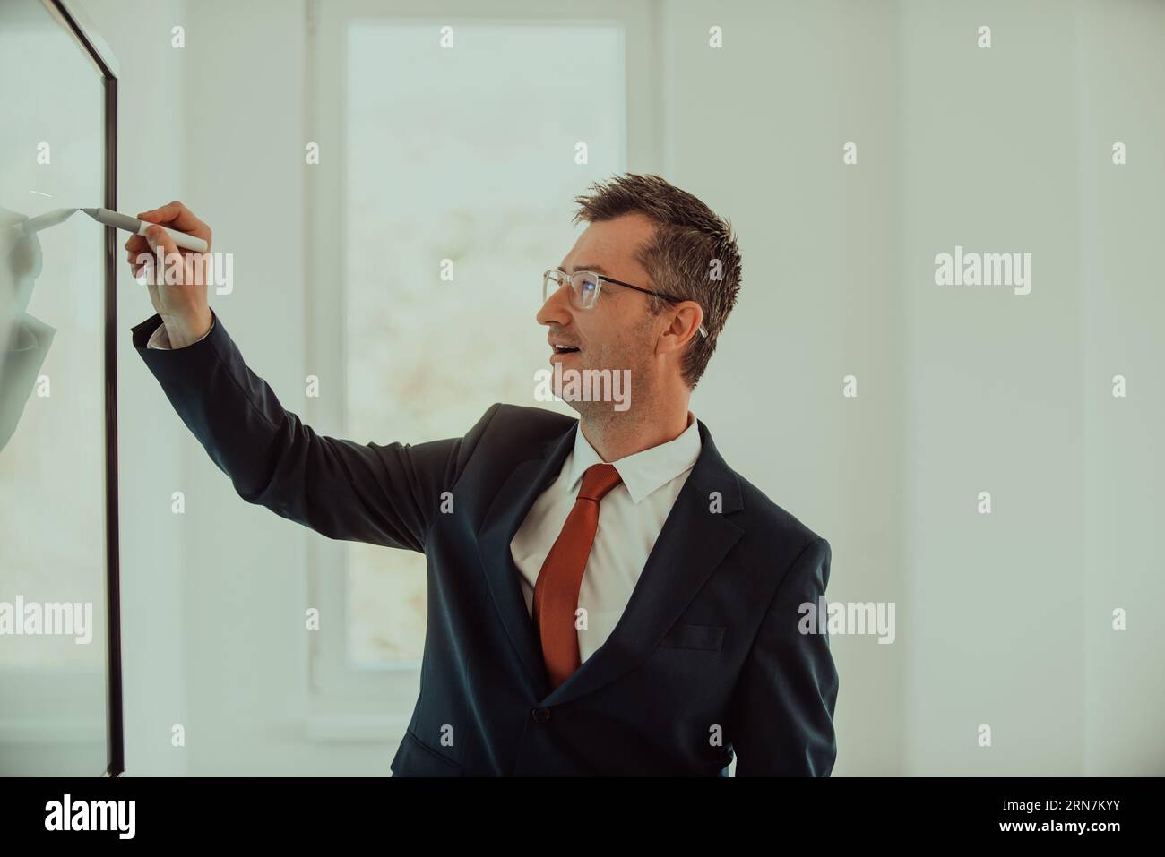 A modernly dressed professor engages in educating students, who listen ...