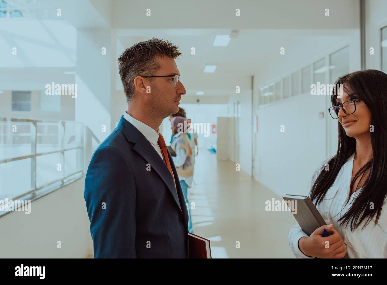 Business colleagues engage in a knowledge-sharing conversation during a ...