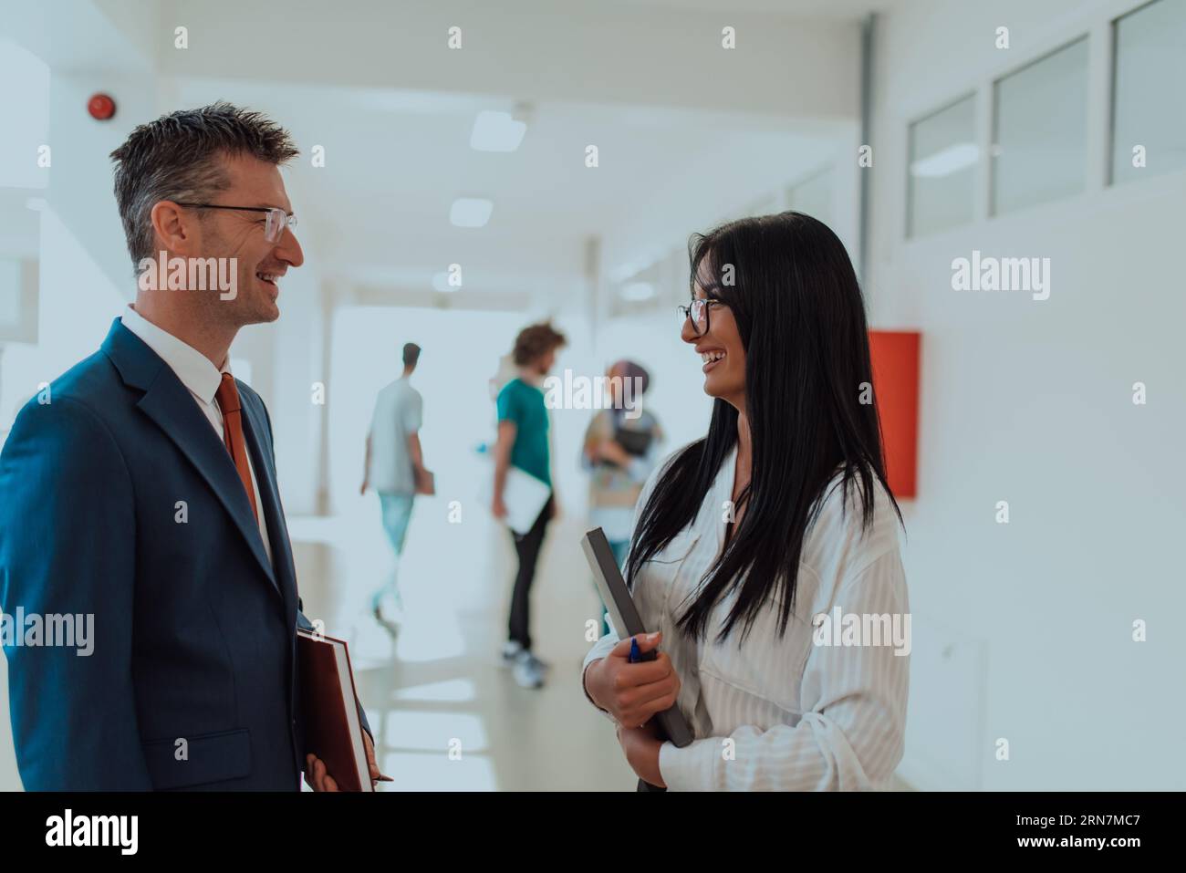 Business colleagues engage in a knowledge-sharing conversation during a ...