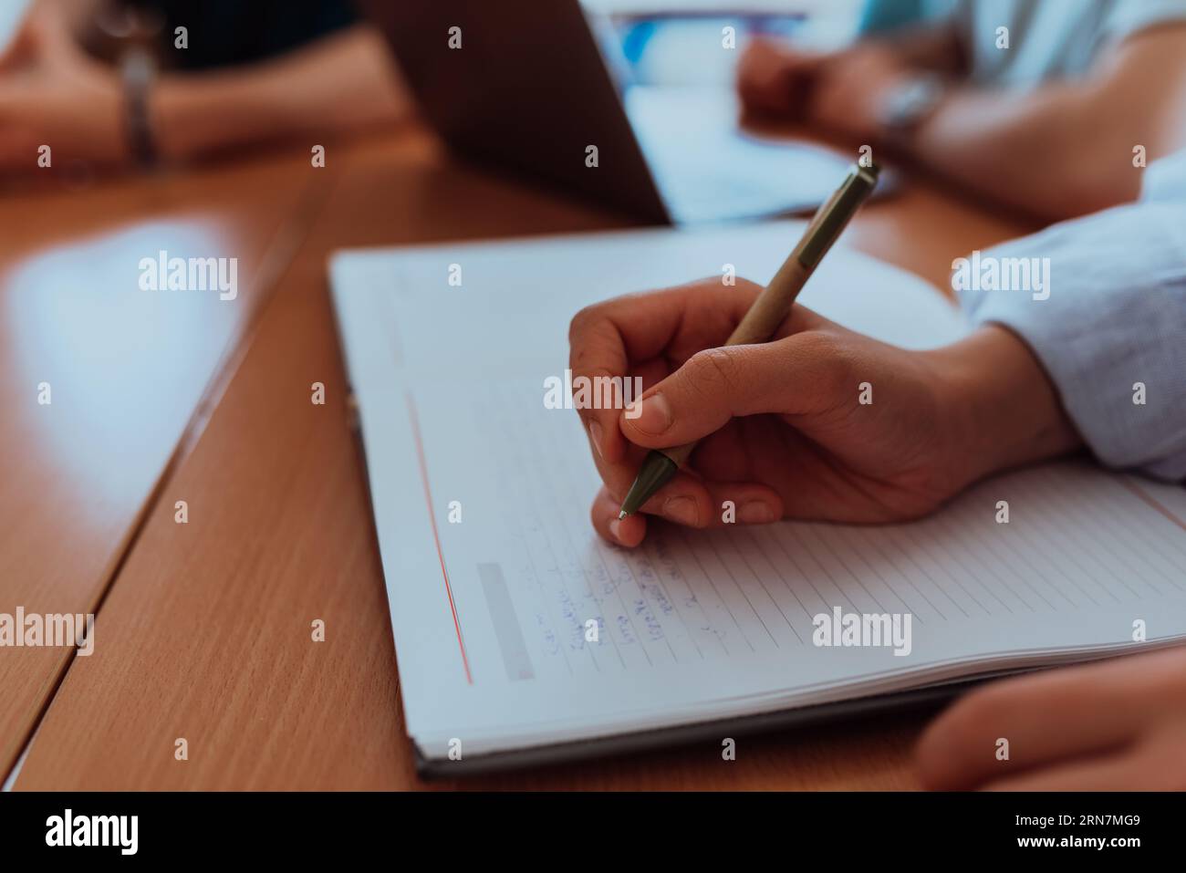 A female hand diligently records essential business ideas in a notebook ...