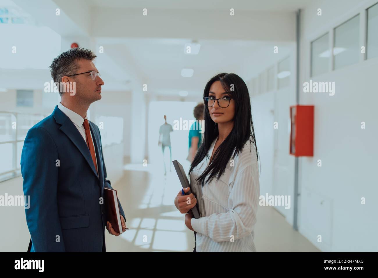 Business colleagues engage in a knowledge-sharing conversation during a ...