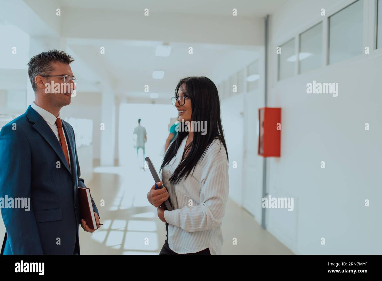 Business colleagues engage in a knowledge-sharing conversation during a ...