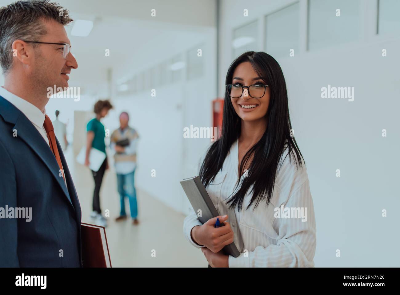 Business colleagues engage in a knowledge-sharing conversation during a ...