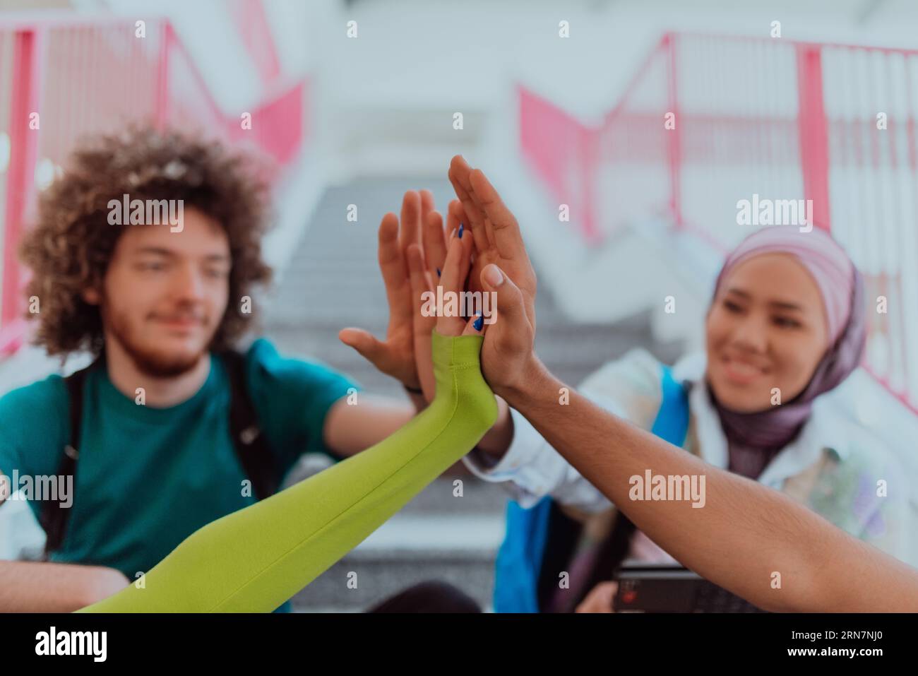 A diverse group of students symbolizes unity as they interlace their ...