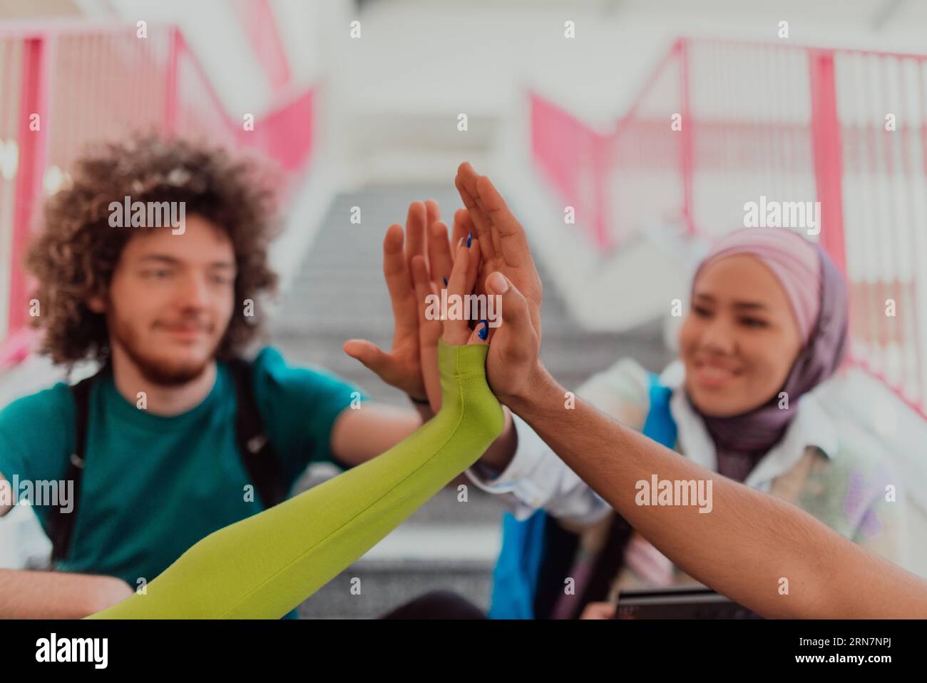 A diverse group of students symbolizes unity as they interlace their ...