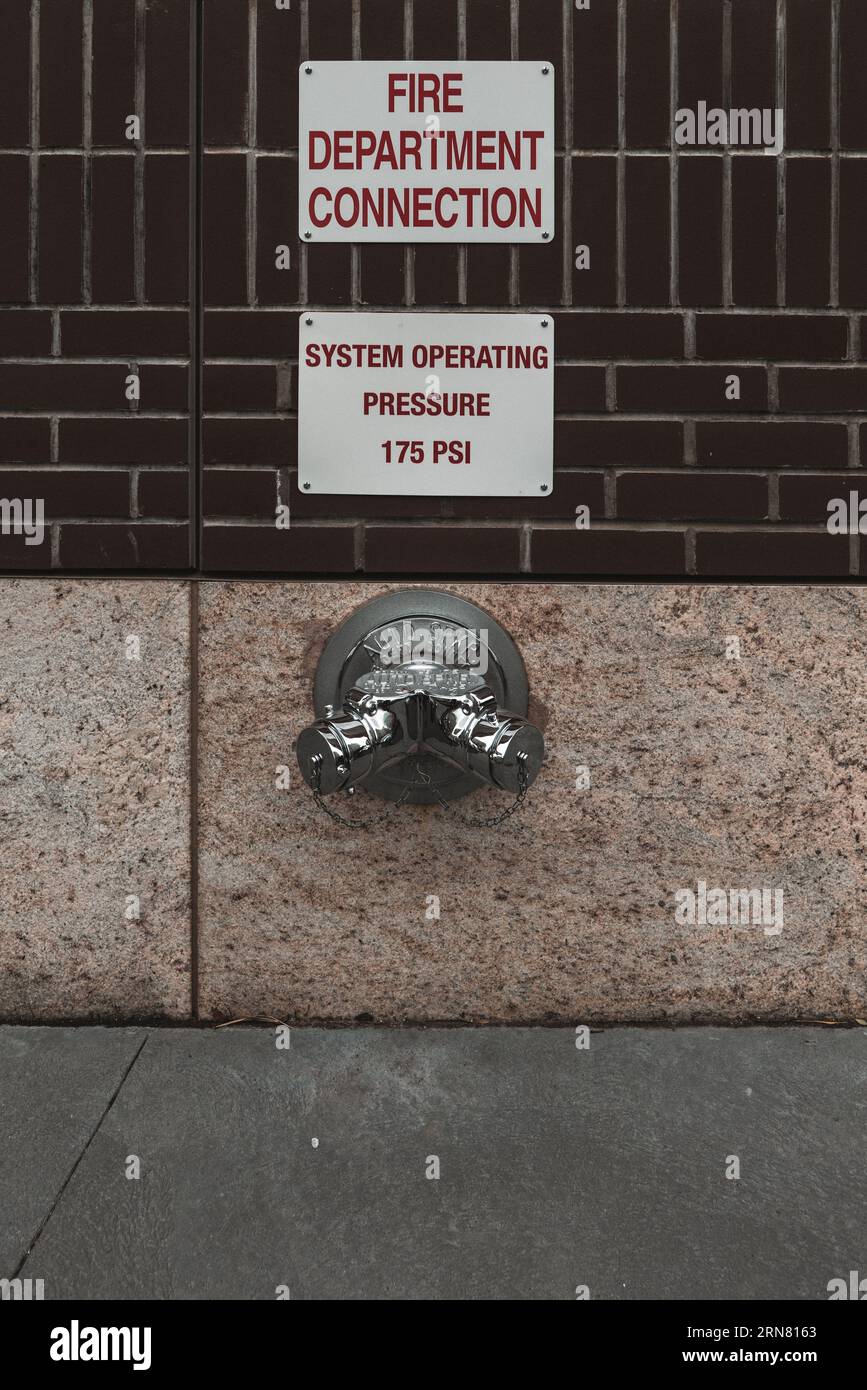 Fire hydrant water pipe, mounted in a building wall. Manhattan USA ...