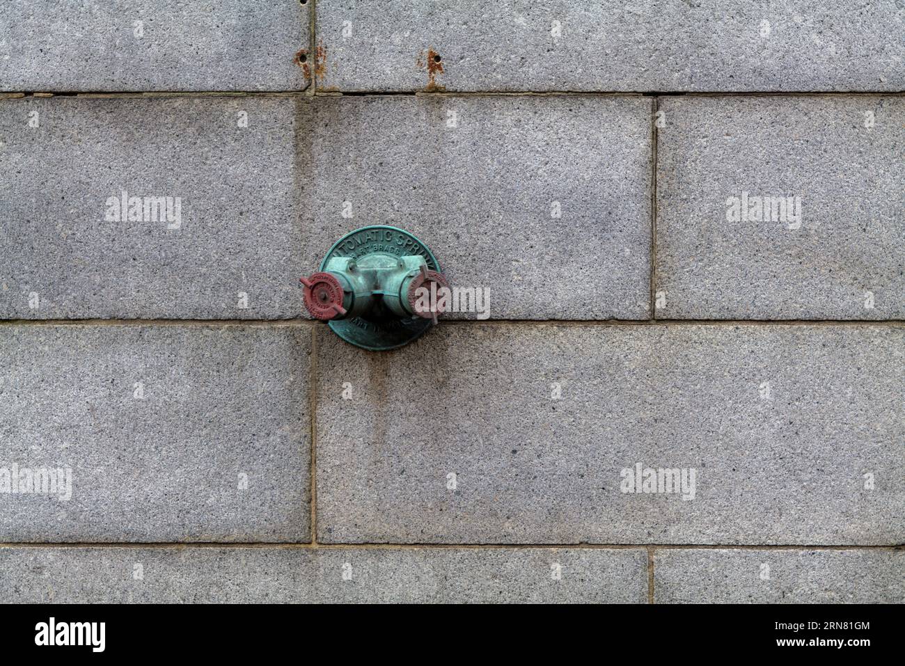 Fire hydrant water pipe, mounted in a building wall. Manhattan USA ...