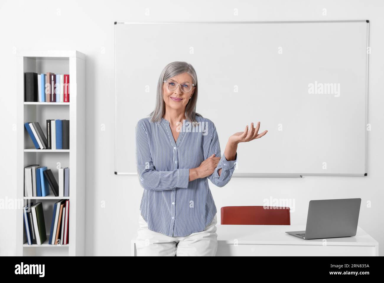 Portrait of smiling professor near whiteboard in classroom Stock Photo ...