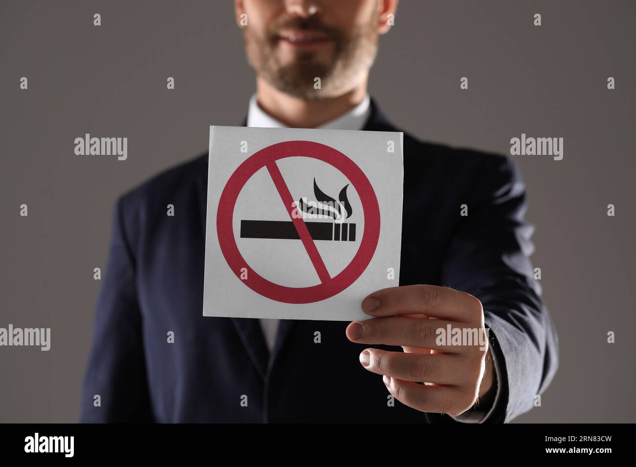 Man holding card with no smoking sign on gray background, closeup Stock ...
