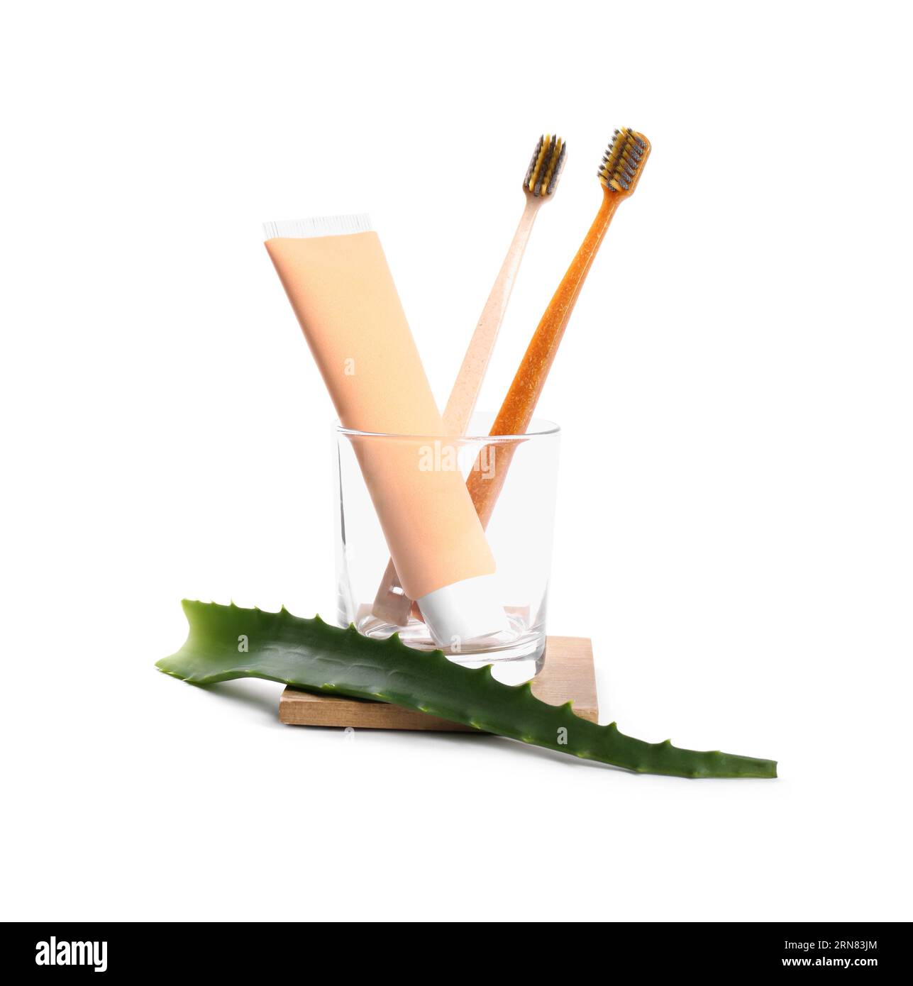 Tube of toothpaste, brushes and aloe vera leaf on white background ...