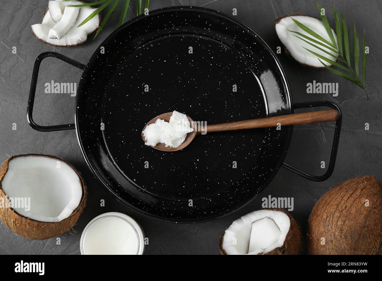 Flat lay composition with frying pan and organic coconut cooking oil on ...